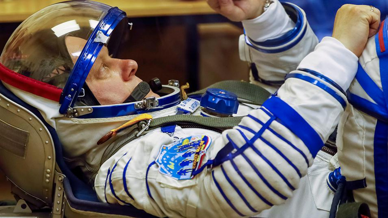 Russian Cosmonaut Captures Satellite Passing Space Station